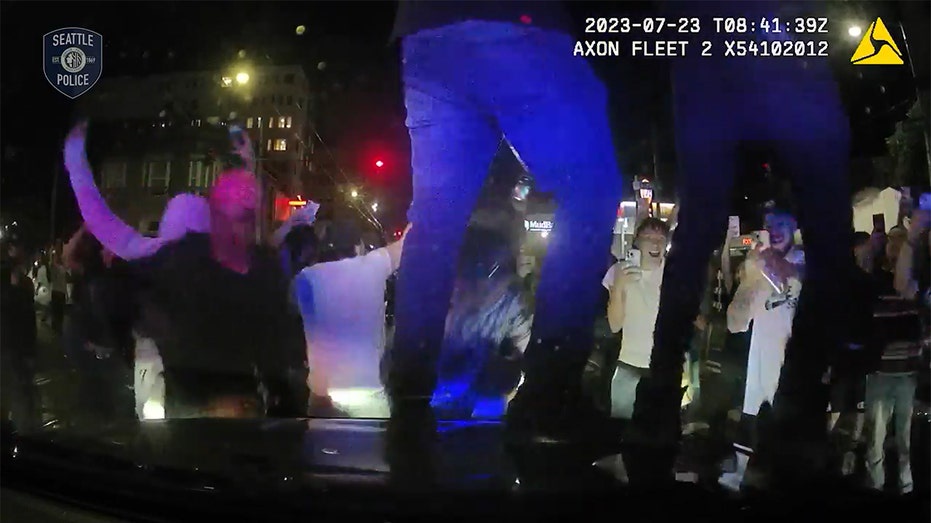 Video shows crowd jumping on hood of police vehicle hours before ...