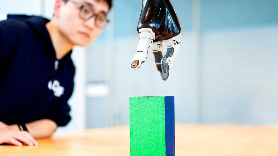 AI enables paralyzed man to control robotic arm with brain signals