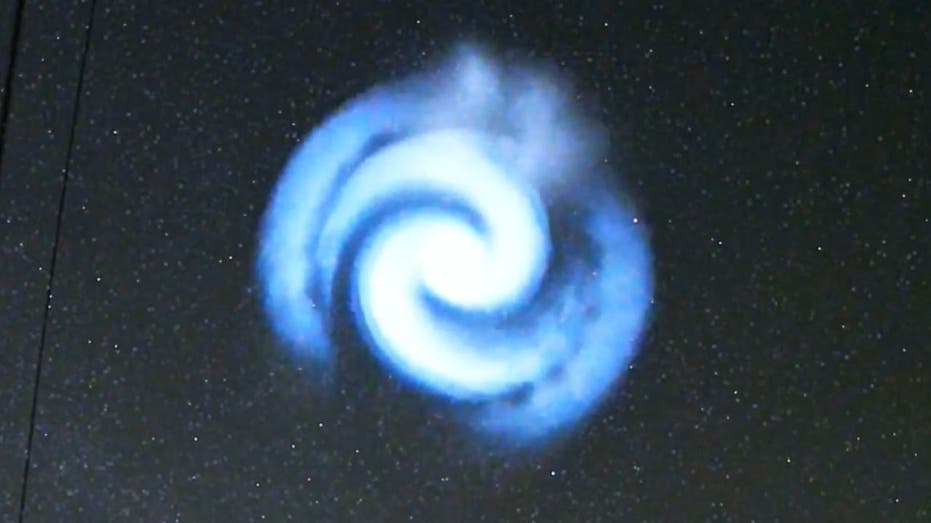 Spectacular blue spiral light brightens up night sky, likely from Space ...