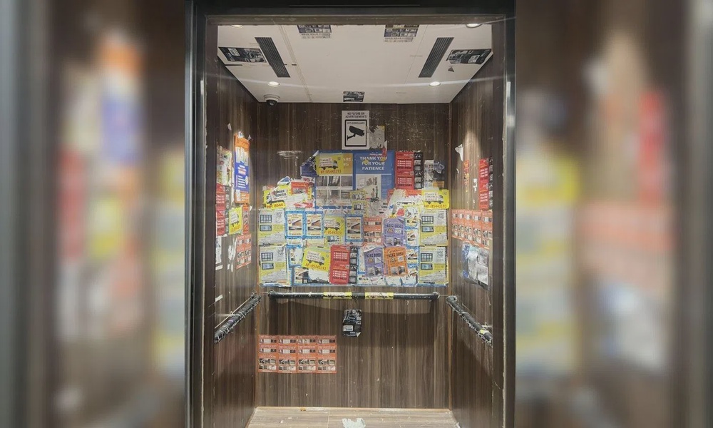 Lift wall plastered with flyers despite CCTV warning sign: 'I burst out ...