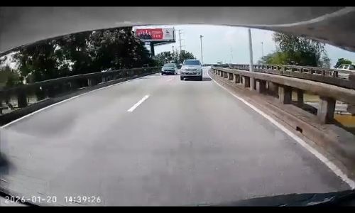 A police officer can be seen hiding beneath the exit ramp of a flyover ...