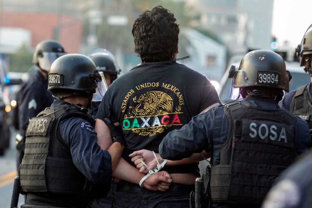 WATCH: L.A. Police Detain Reporter Live On-Air During Anti-ICE Riots