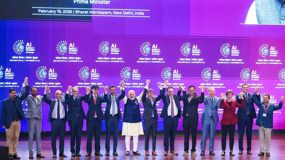 Sam Altman and Dario Amodei doge hand-holding chain during Modi’s AI summit