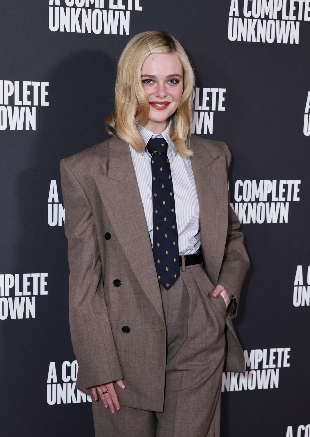Elle Fanning Revives the Neck Tie Trend In an ’80s Power Suit