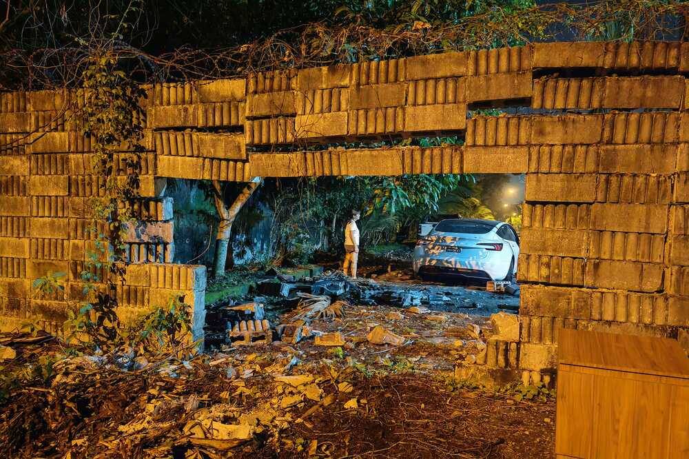 Tesla Car Crashes Through Brick Wall