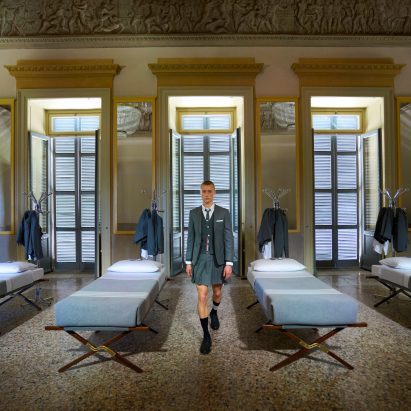 Models nap on Thom Browne bedding during Milan design week performance