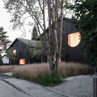 Charred timber and exposed concrete defines conjoined houses in Germany ...