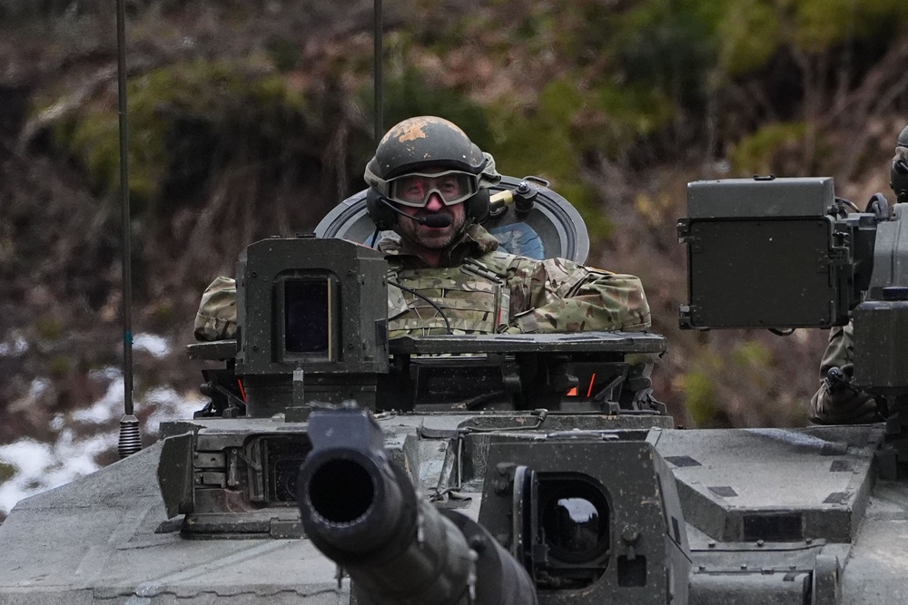 William rides in tank on visit to British troops helping defend Estonia