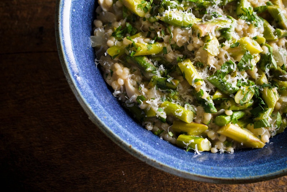 Couscous gets the risotto treatment in this creamy springtime recipe