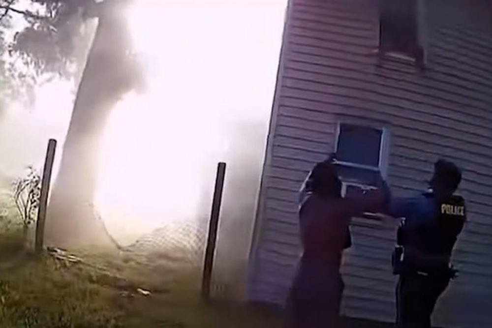 Heart-stopping moment police catch child jumping from window of burning ...