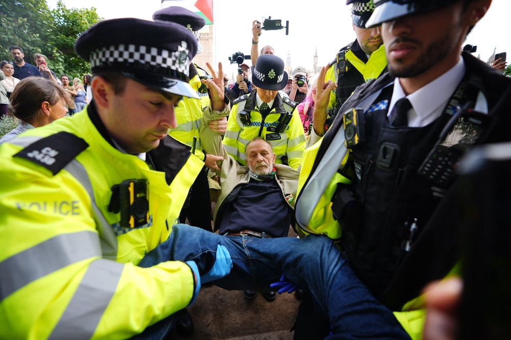 Police draw batons as violent clashes erupt during mass arrests at ...