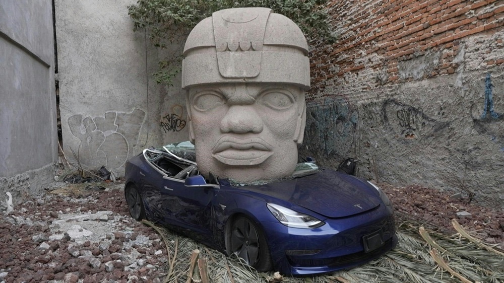 Mexican artist crushes Tesla under giant stone head