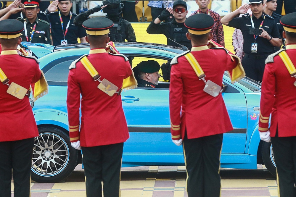 King arrives in Proton Satria Neo R3 to loud cheers as Malaysians ...