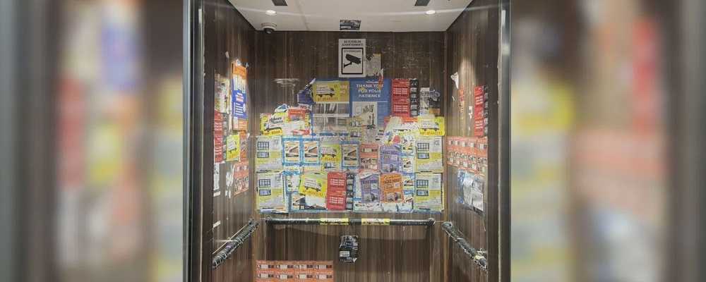 Lift wall plastered with flyers despite CCTV warning sign: 'I burst out ...