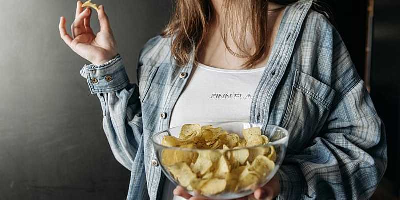 Adults in England eat the equivalent of 155 bags of crisps’ worth of ...