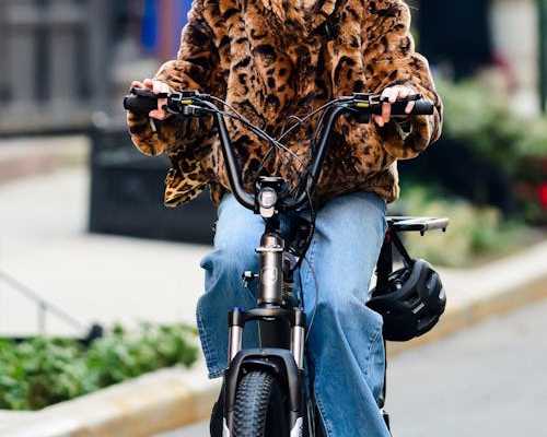 Jennifer Lawrence's Faux Fur Coat & Cult Blue Jeans Make Biking Look Cool